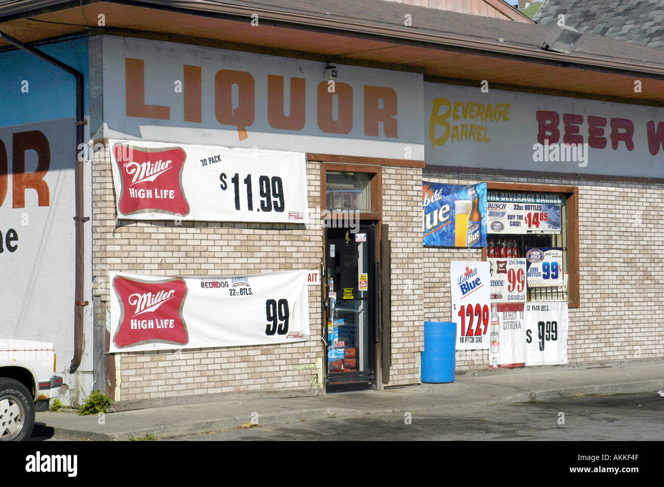 Many signs on side of party store exterior walls promoting BEER sales ...