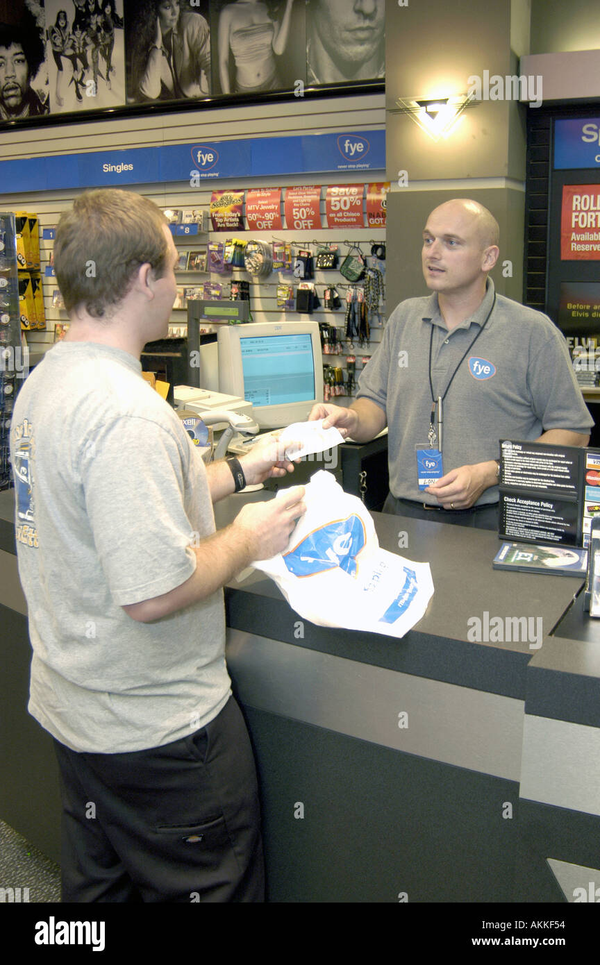 Adult male makes purchase in a retail music store Stock Photo - Alamy