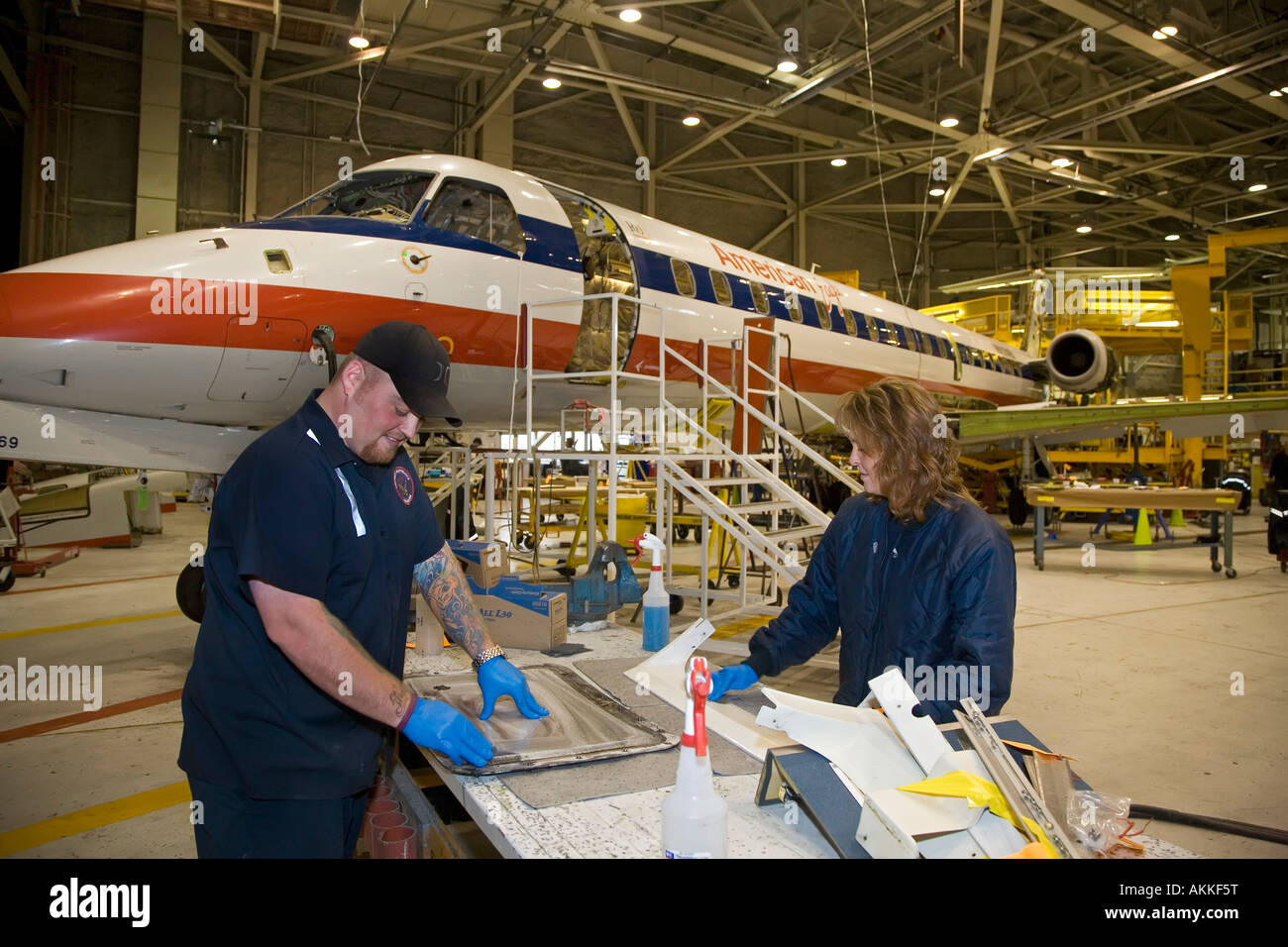 Workers do heavy maintenance on American Eagle Embraer jet airplanes at ...