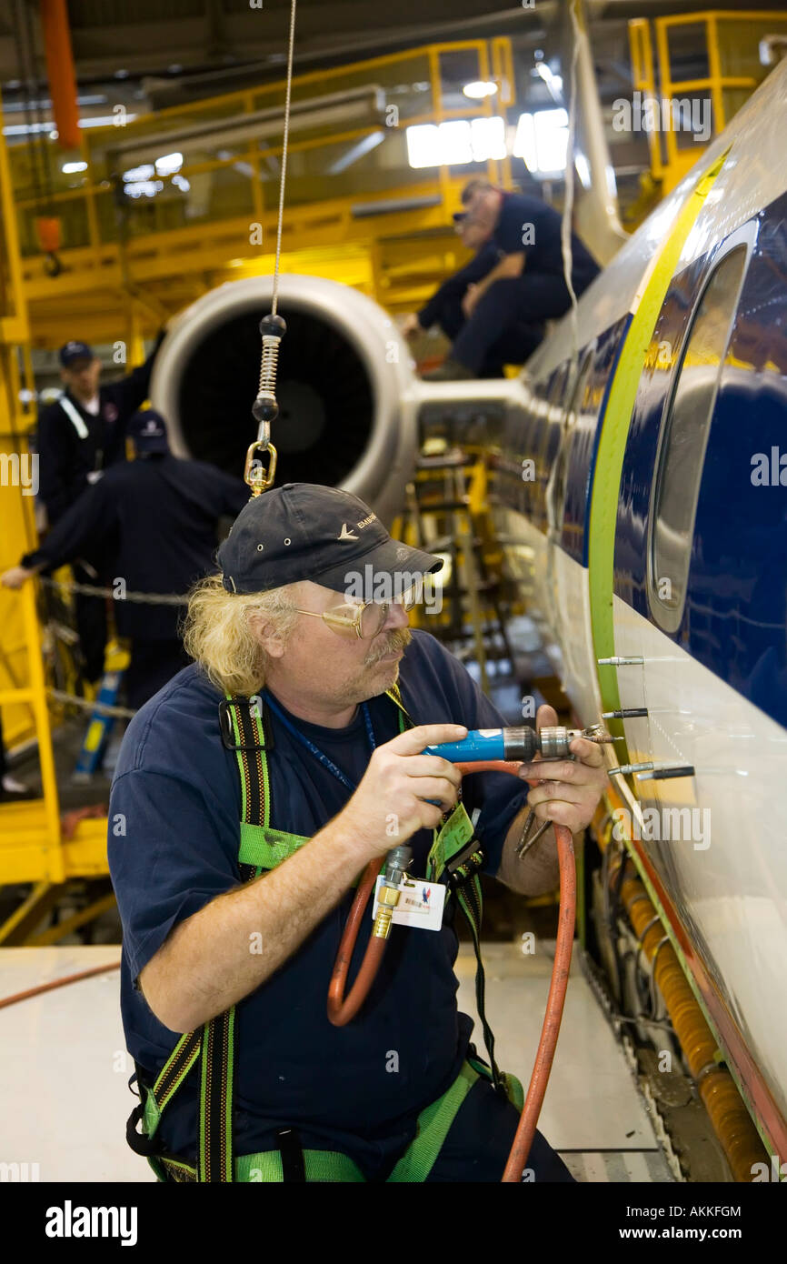 Workers do heavy maintenance on American Eagle Embraer jet airplanes at ...