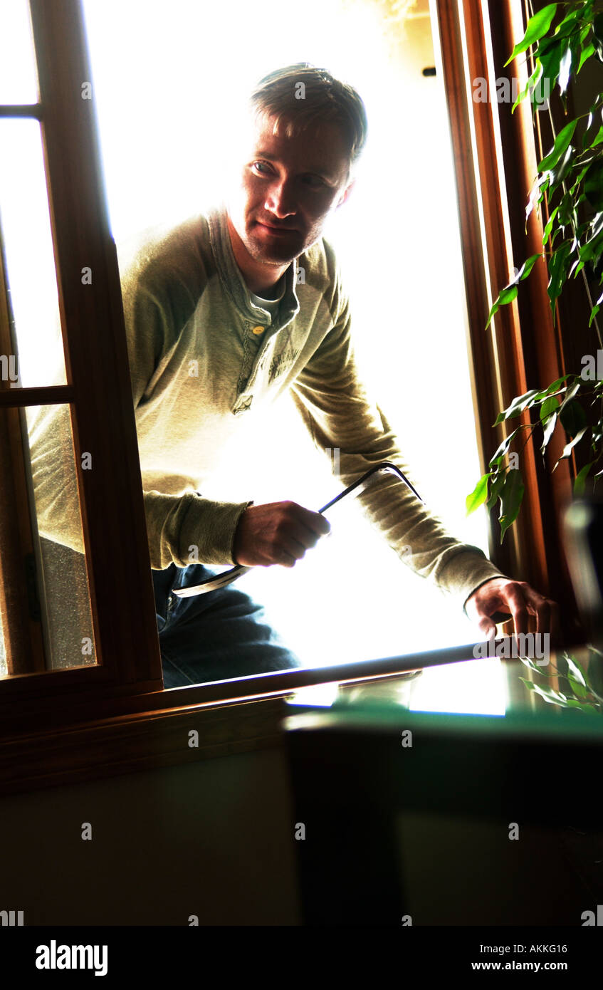 Man breaking into home Stock Photo - Alamy