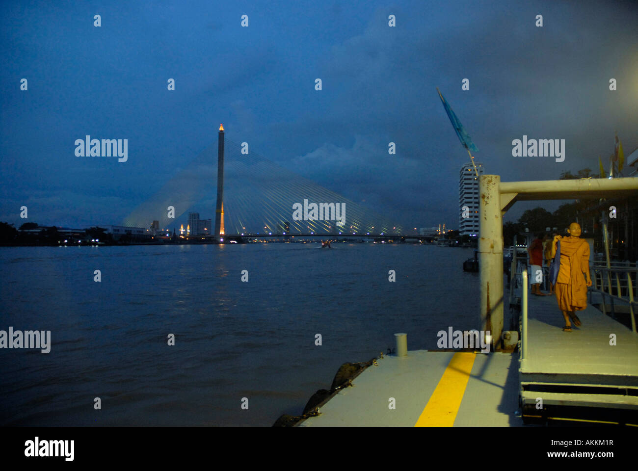 Thai monk waiting for Chao Phraya ferry at Phra Athit pier Stock Photo ...