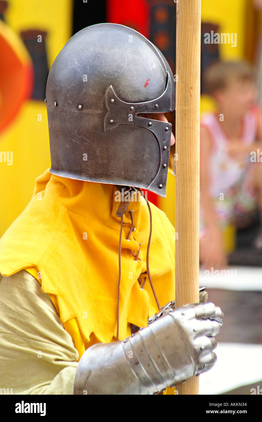 Yellow knight boy inhelmet standing at chessboard at street of Banska ...