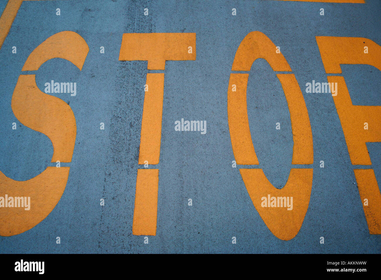 stop painted on pavement in yellow Stock Photo - Alamy
