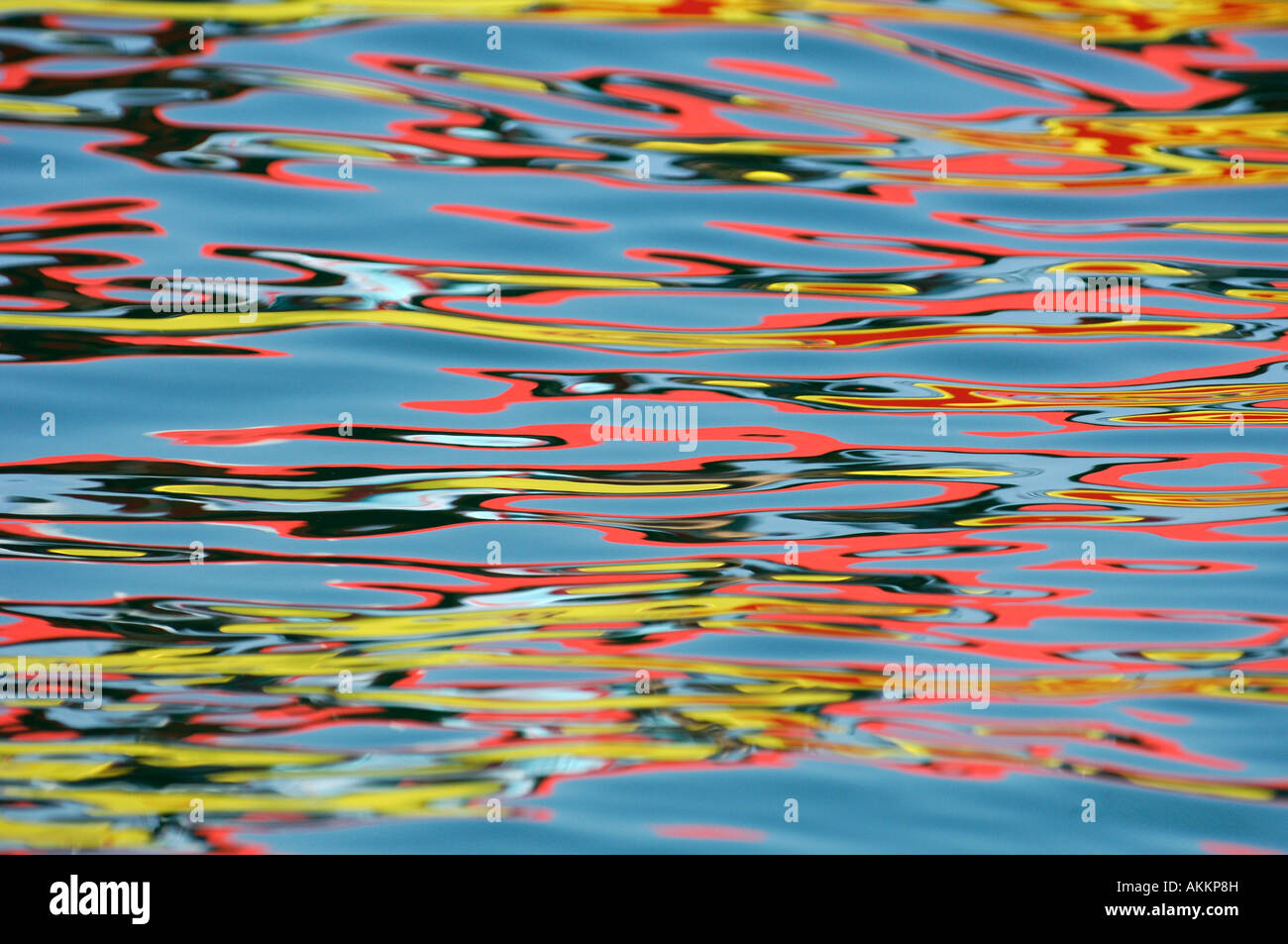 Ripples on still water reflecting red yellow and orange Stock Photo - Alamy