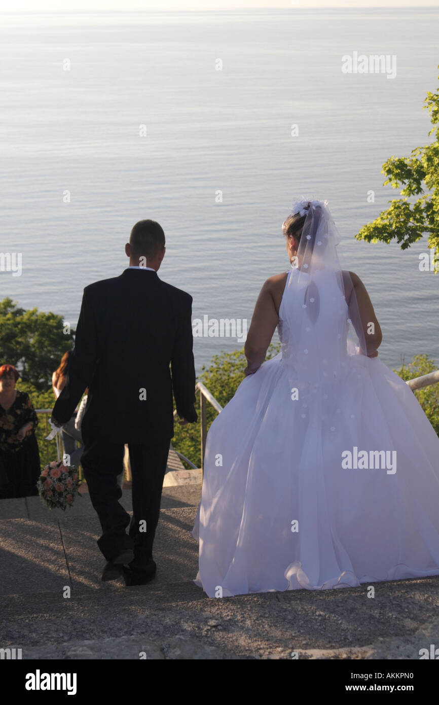 Bride and groom descending the steps at Valaste Waterfall in the Ontika ...