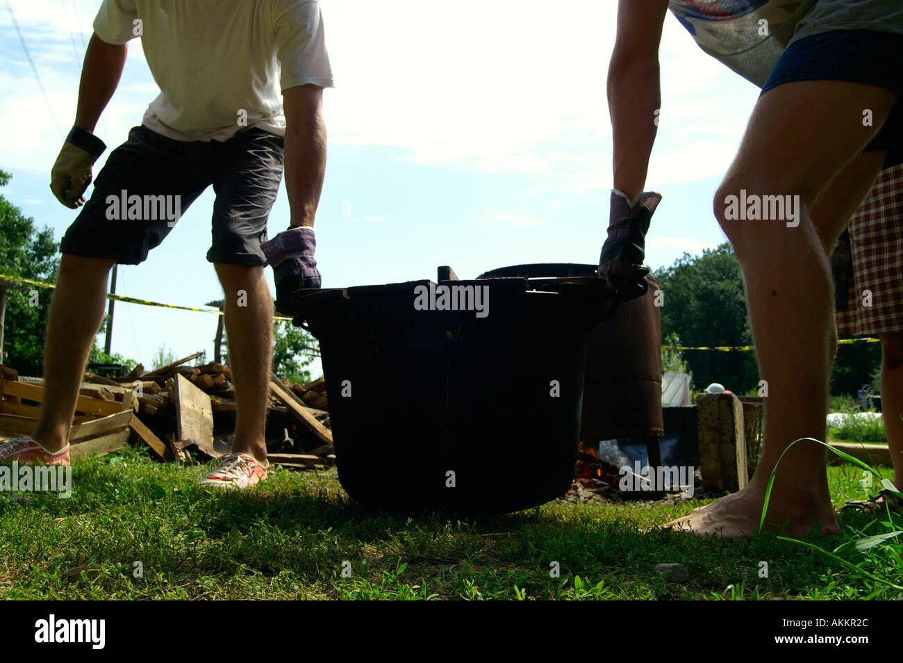 Two boys carrying Cauldron Stock Photo - Alamy