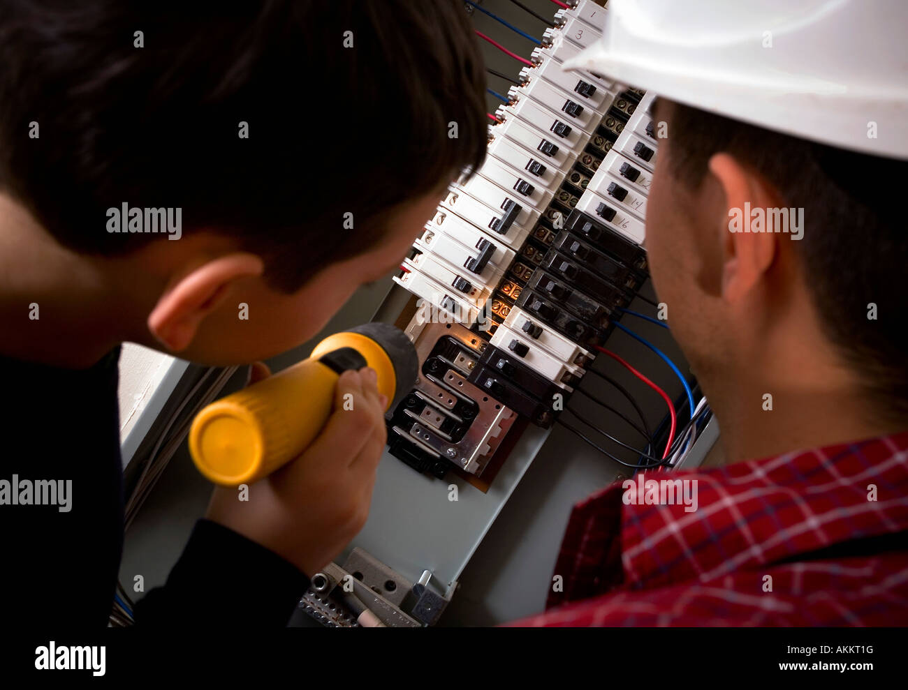 Men looking at fuse box Stock Photo - Alamy