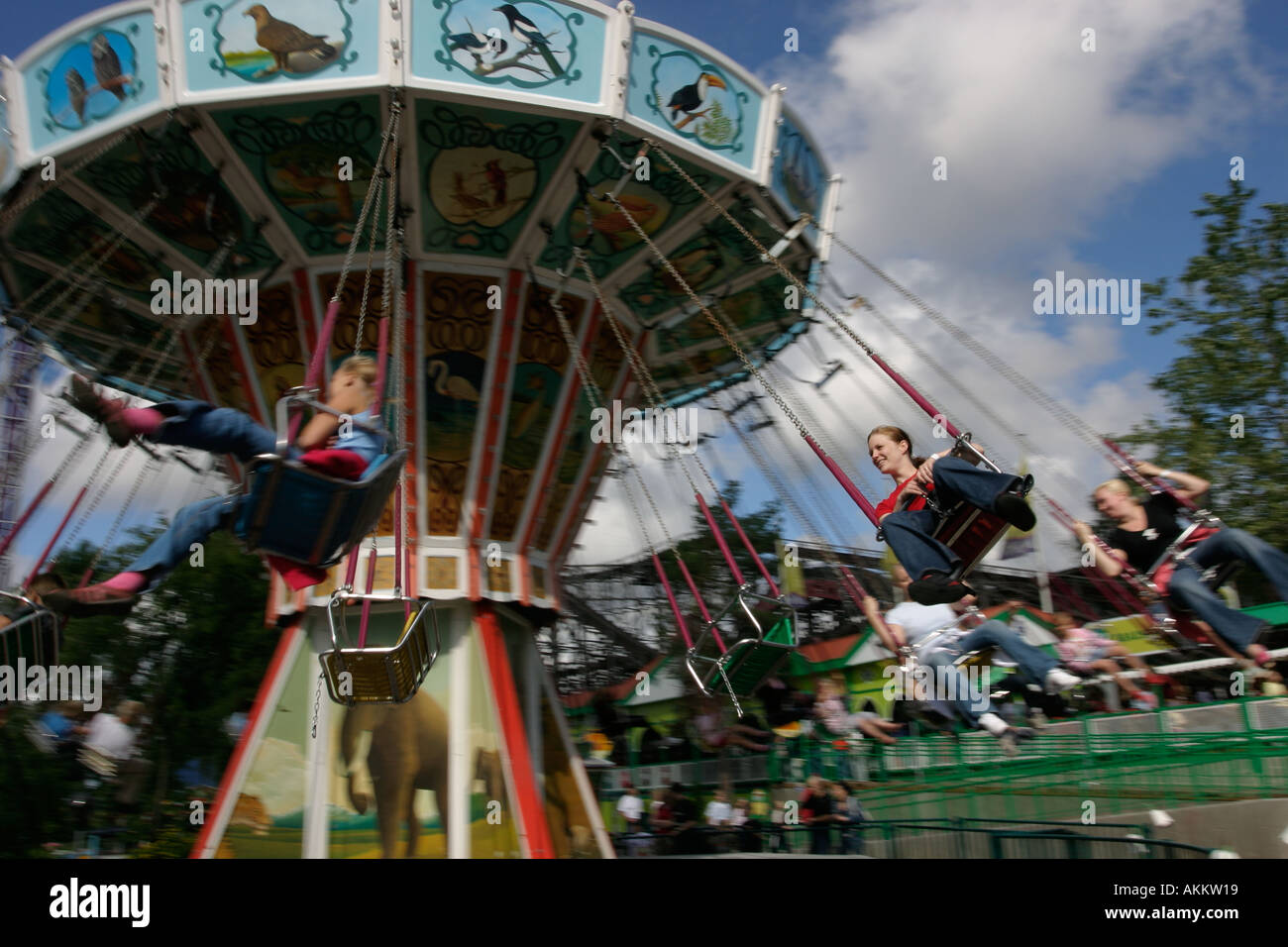 People on roundabout carousel Stock Photo - Alamy
