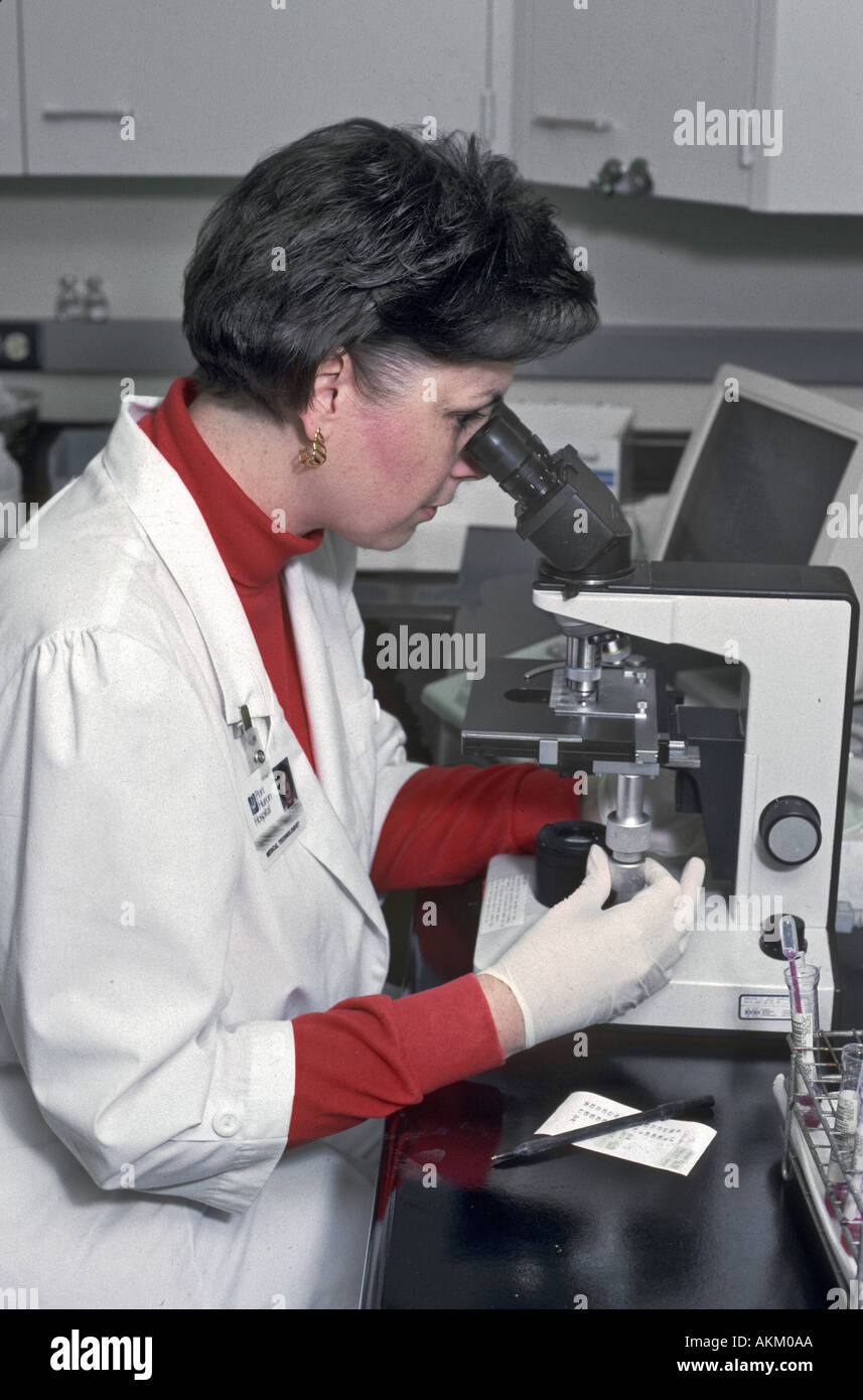Female lab technician wears protective gloves while studying blood ...