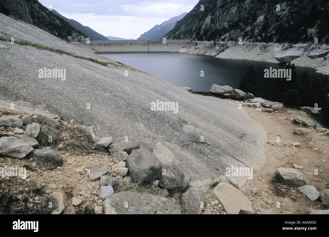 Dam with lake Embassament de Cavallers on mountain river Aiguestortes ...