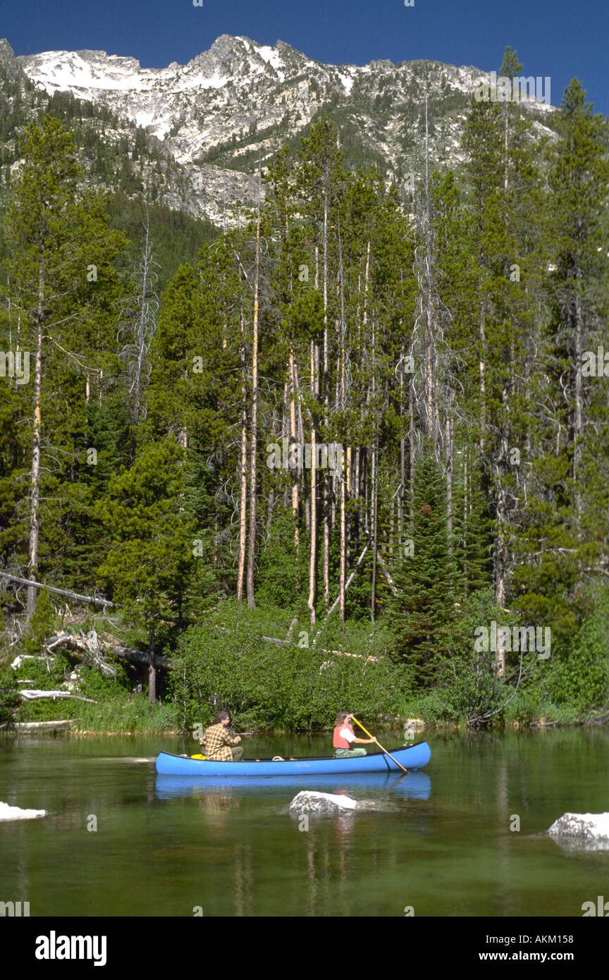 Husband and wife couple canoe on String Lake Grand Teton National Park ...