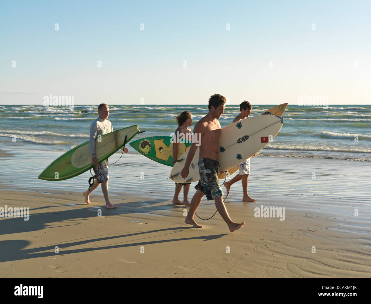 Canada Ontario Sauble Beach surfers walking along the beach with surf ...