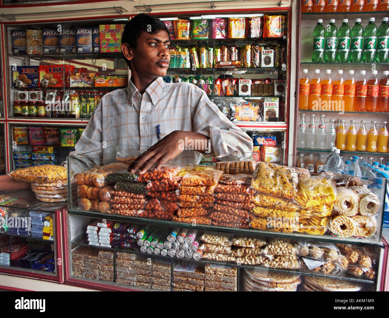 Indian man behind counter in general store Chennai Madras India Stock ...