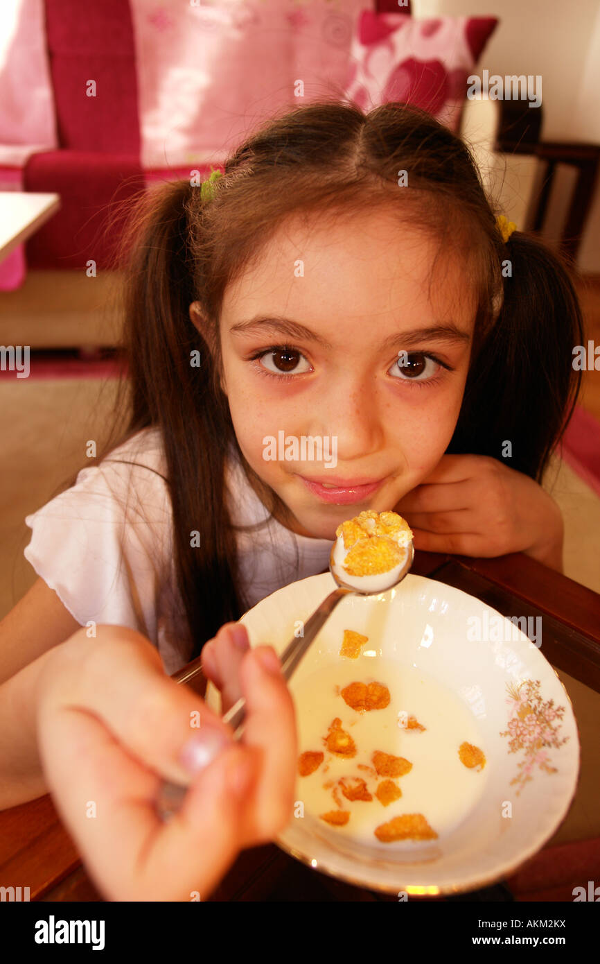 Girl eats cornflakes with milk Stock Photo - Alamy