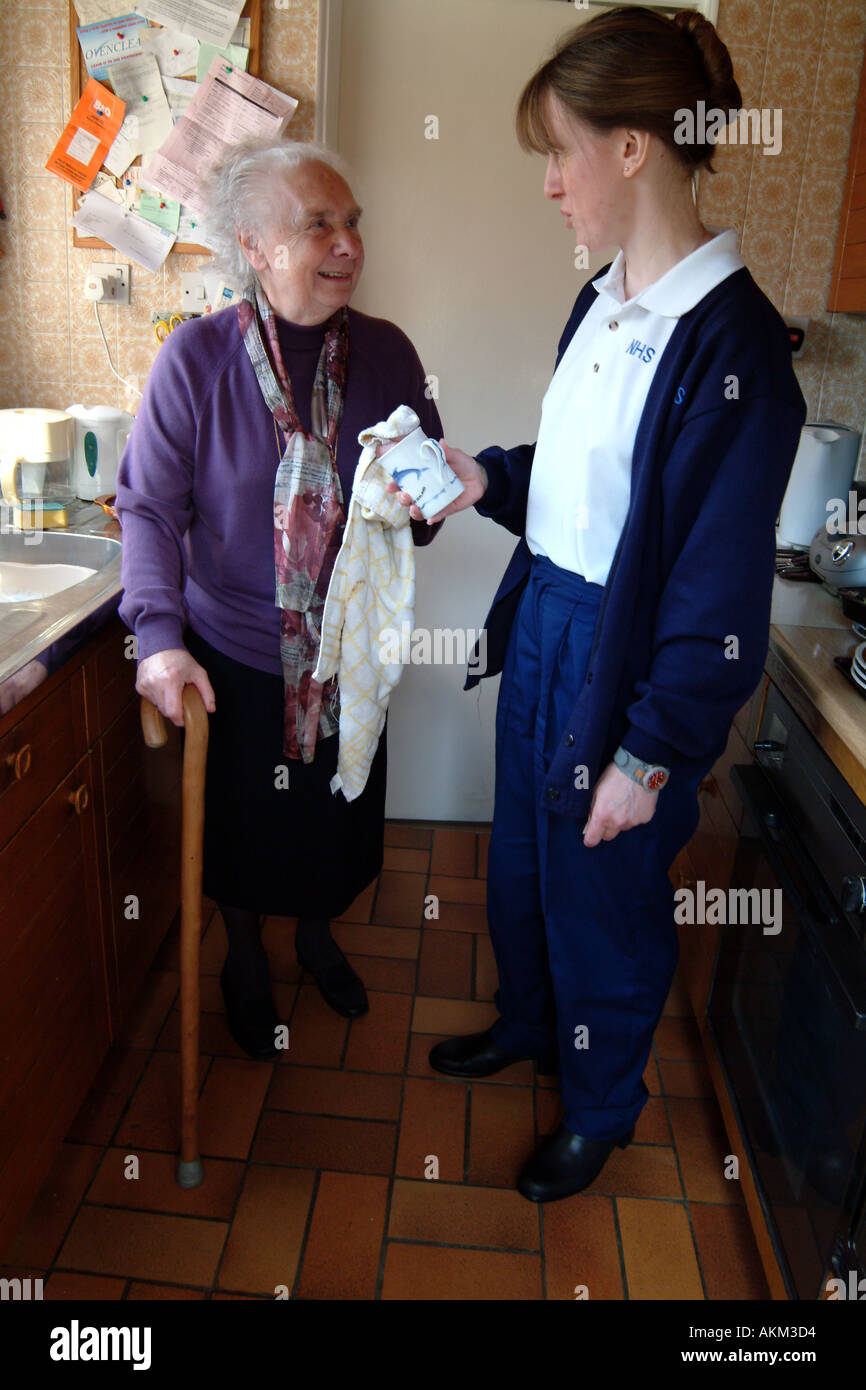 Elderly lady washing up in her kitchen England UK Stock Photo - Alamy