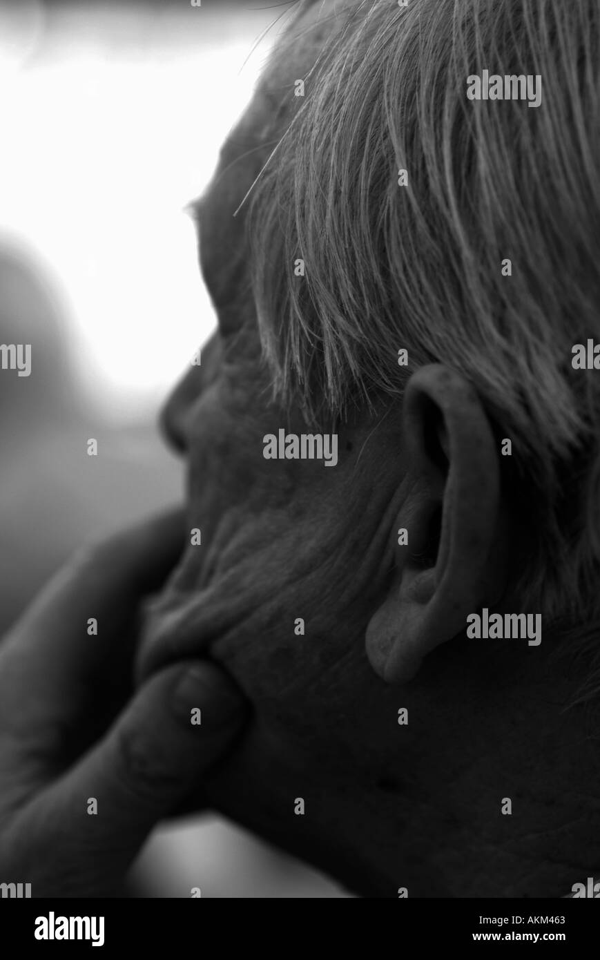Portrait of a elderly man pulling his skin Stock Photo - Alamy