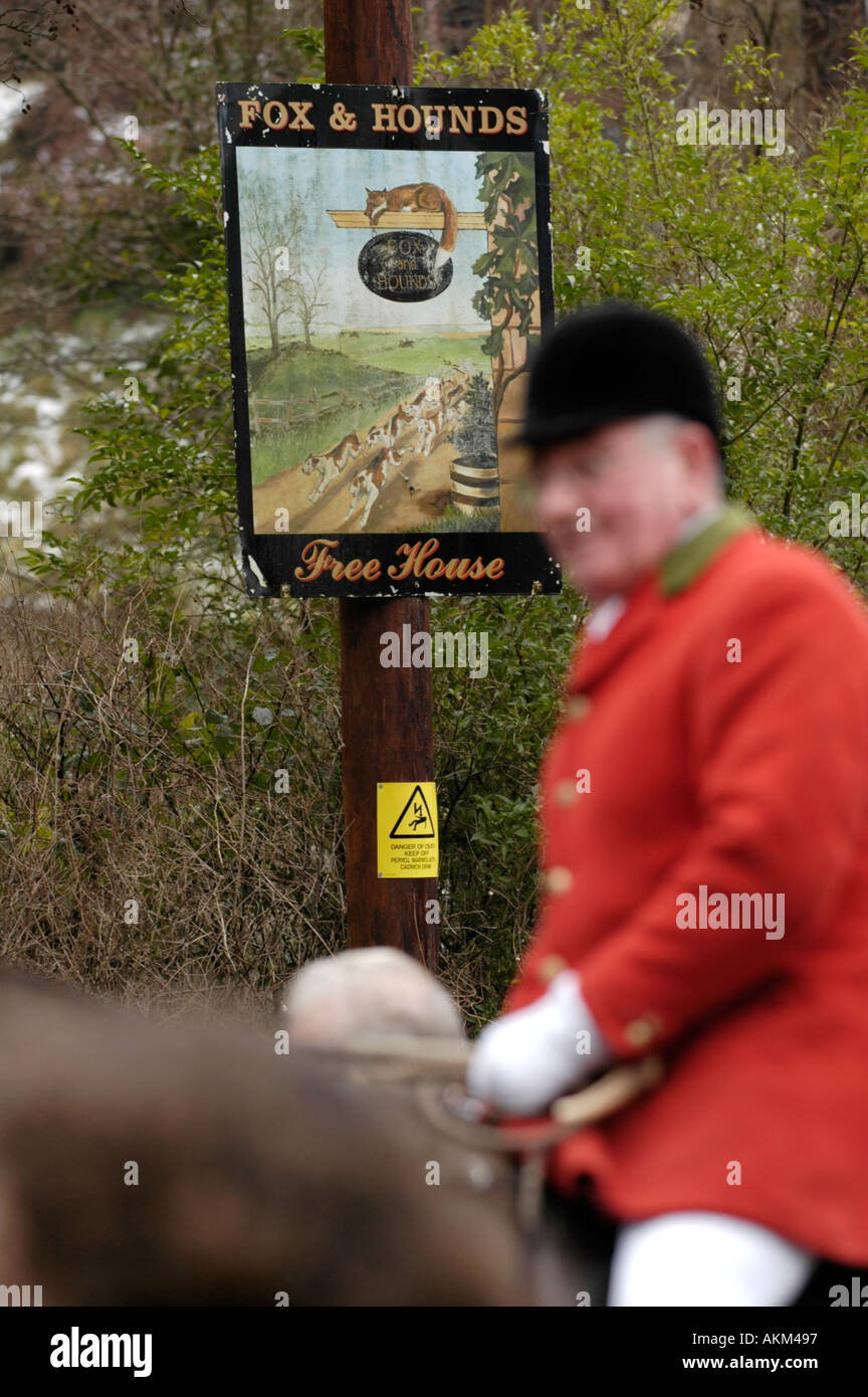 Huntsman on horseback wearing red coat outside Fox and Hounds pub ...