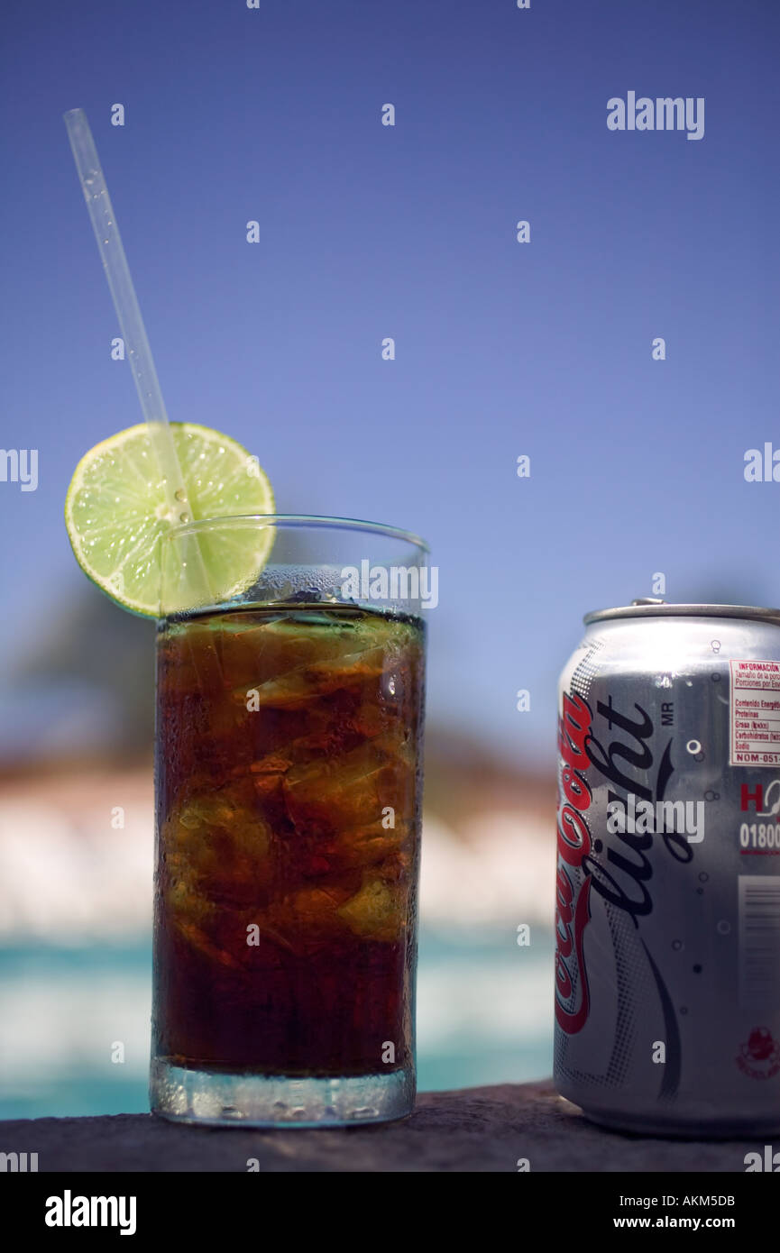 Coca Cola can and glass with lime slice in outdoor setting Cozumel ...