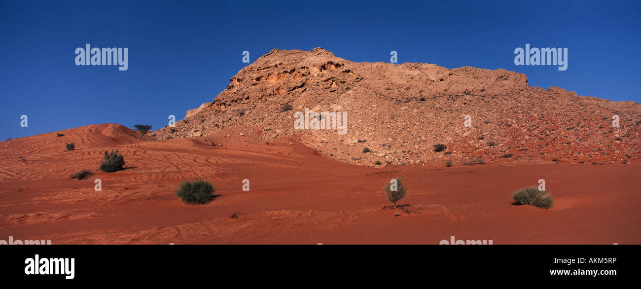 Excursion into the sand dunes Panoramic of red sand desert and rocky ...