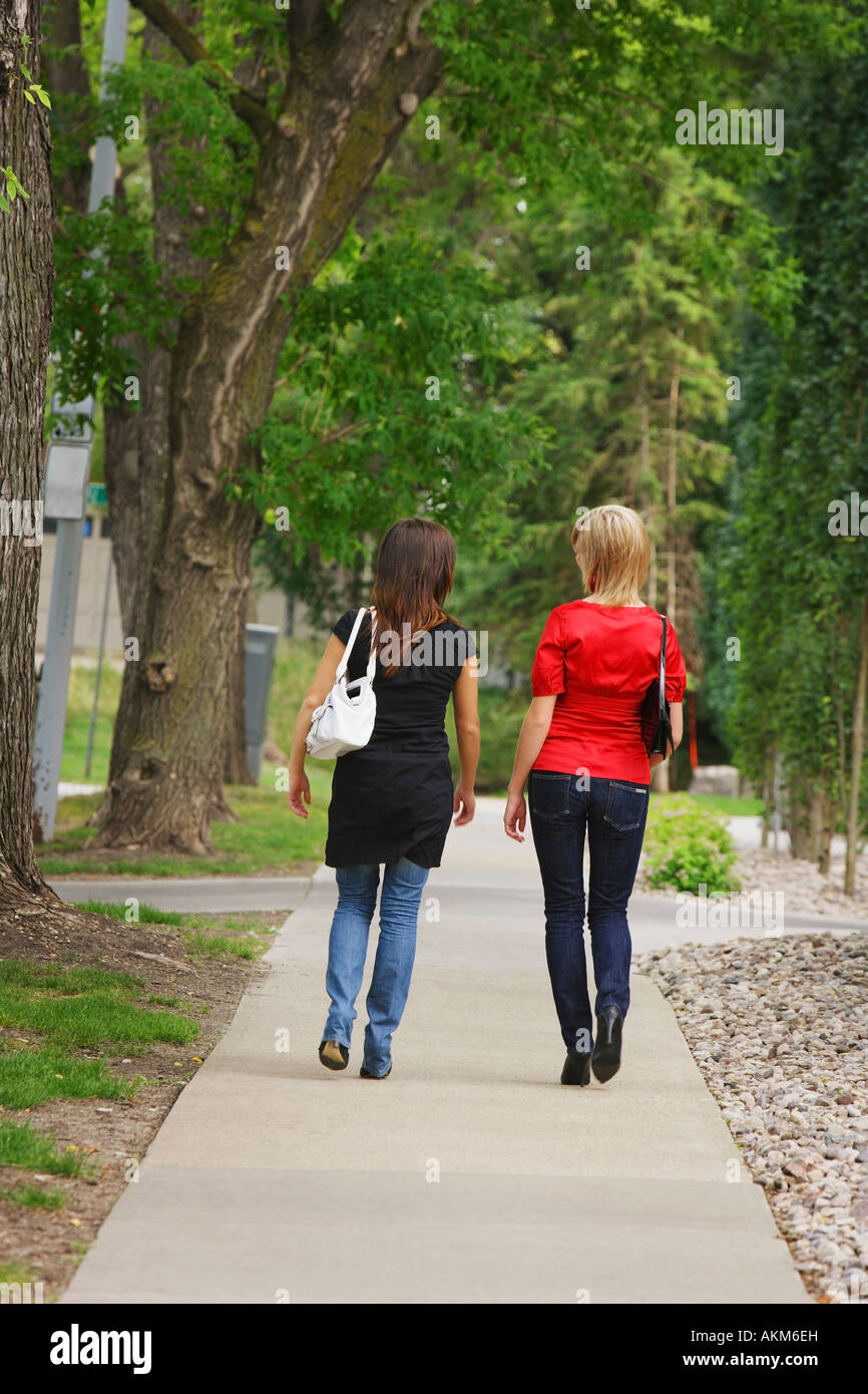 Friends walking on the sidewalk Stock Photo - Alamy