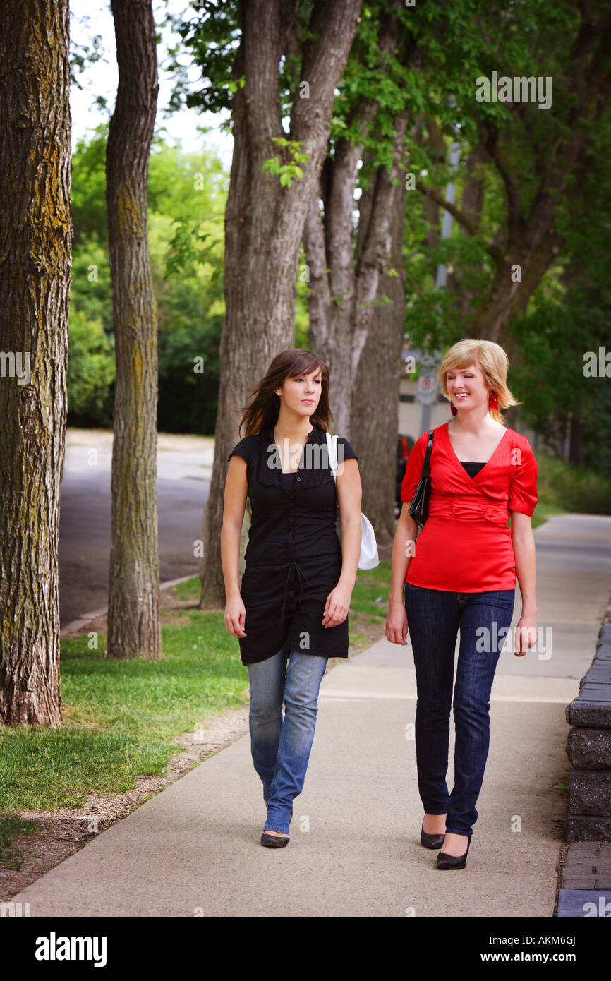 Friends walking and talking Stock Photo - Alamy