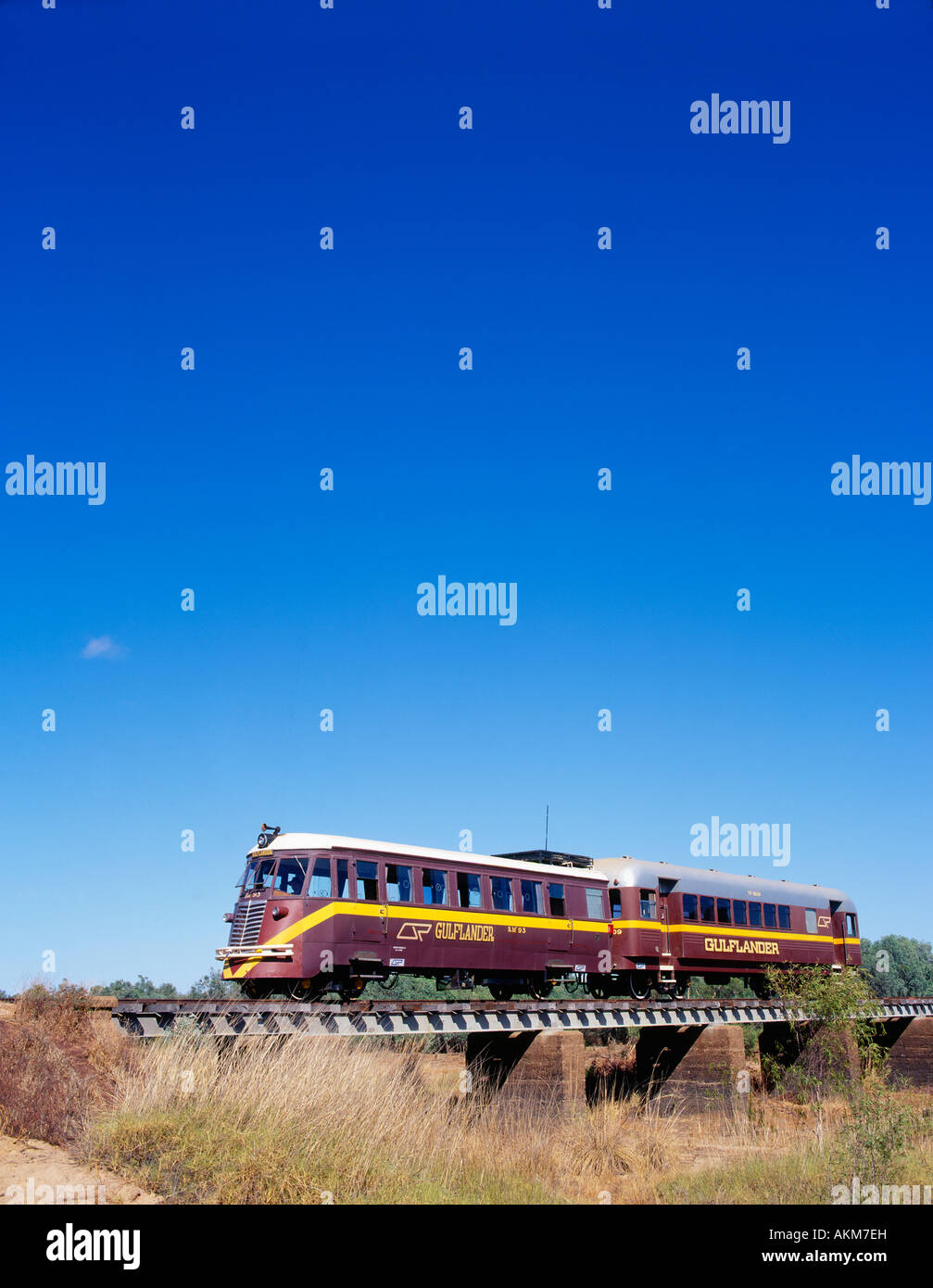 Vintage train The Gulflander RM93 railmotor crossing a bridge in the ...