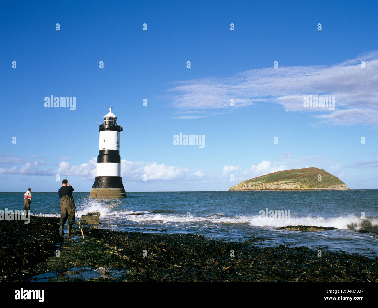 Lighthouse 1837 at Penmon Point and Puffin Island Ynys Seiriol beyond ...