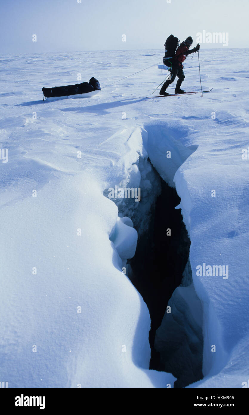 Man crossing big glaciercrack on icecap Greenland Stock Photo - Alamy
