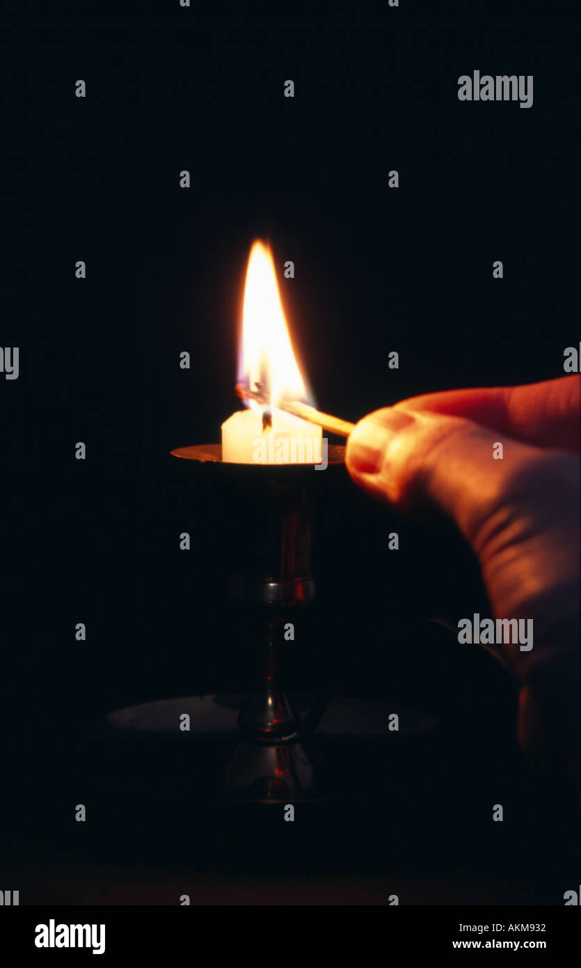 hand setting fire to candle Stock Photo - Alamy