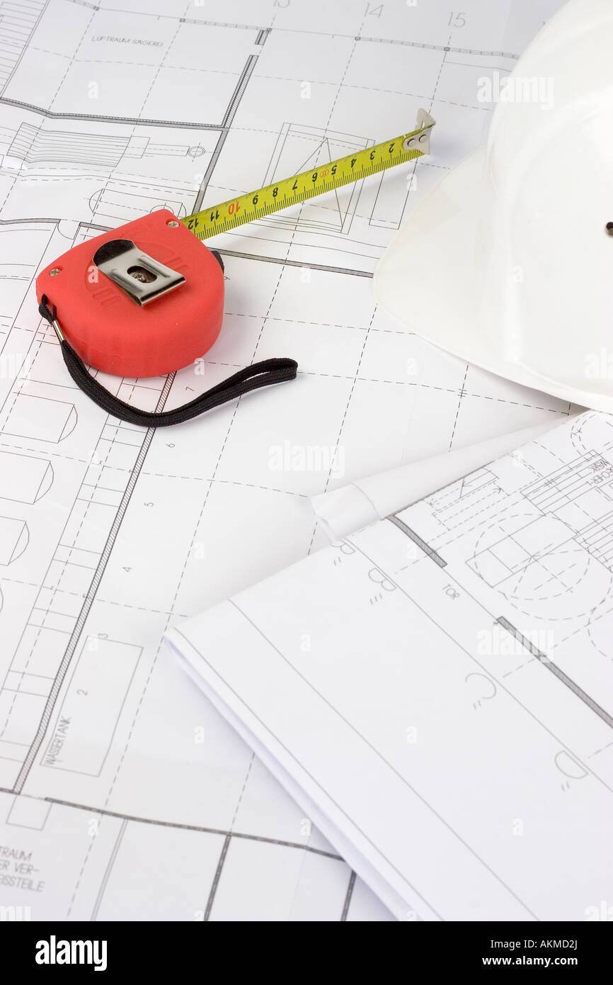 Hardhat and measuring tape lying on construction plans Focus on the ...