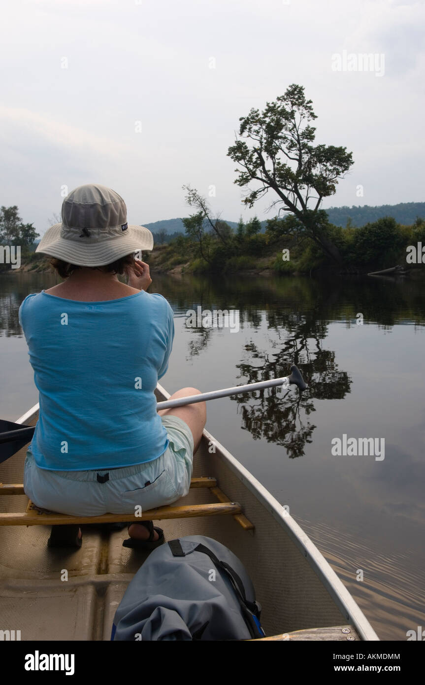 Female canoeist on the Riviere Rouge, Laurentian Mountains, Quebec ...