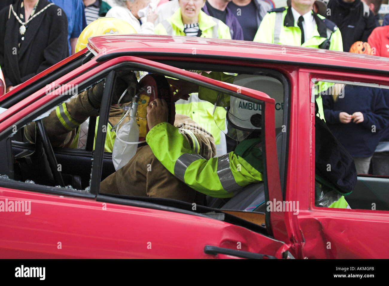 emergency services use a hydralic cutter to treat an injured driver in ...