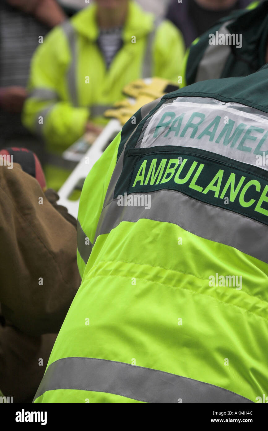 paramedic helping a car crash victim in a practice scenario showing ...