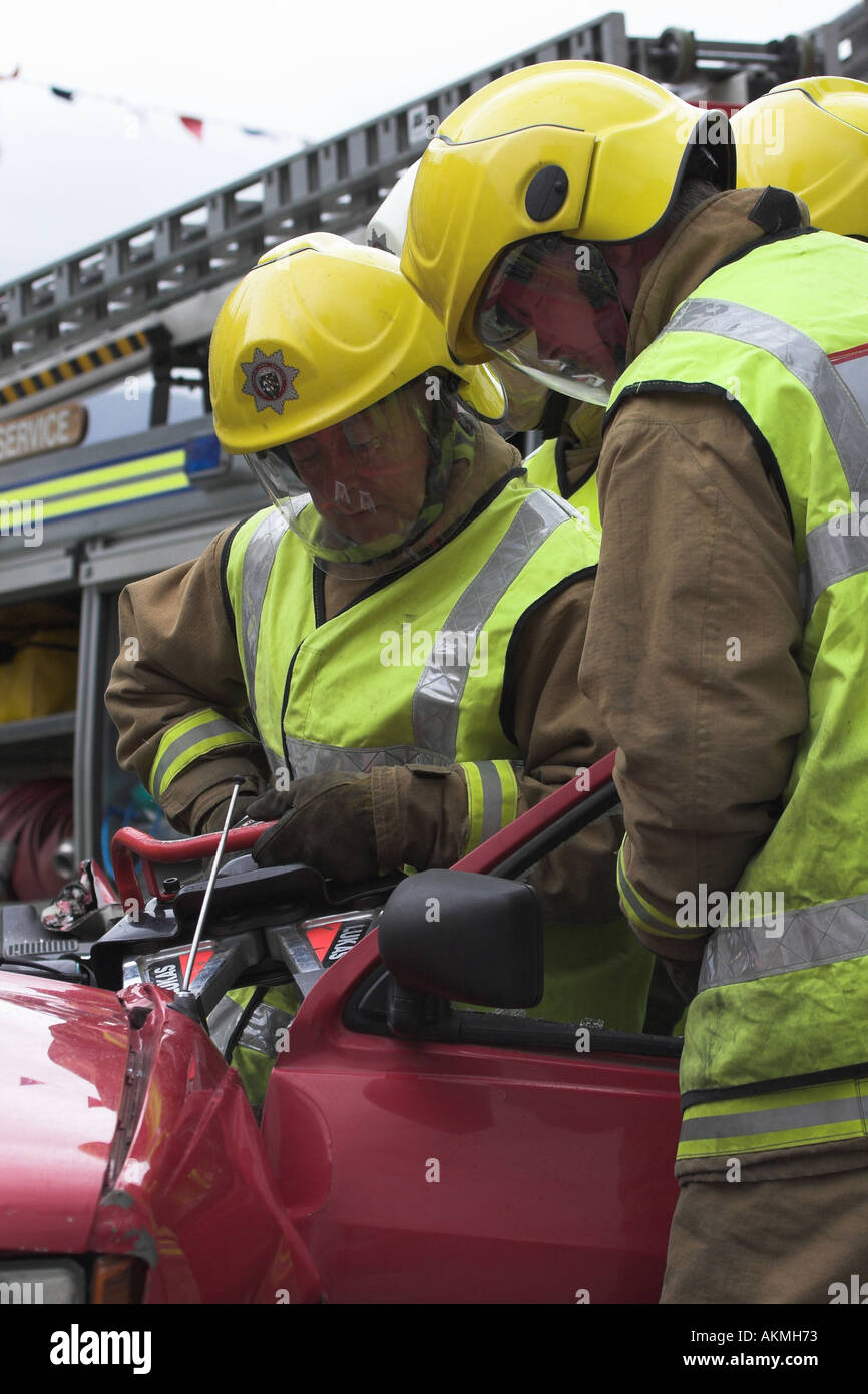 firemen treat an injured driver in a car crash Stock Photo - Alamy