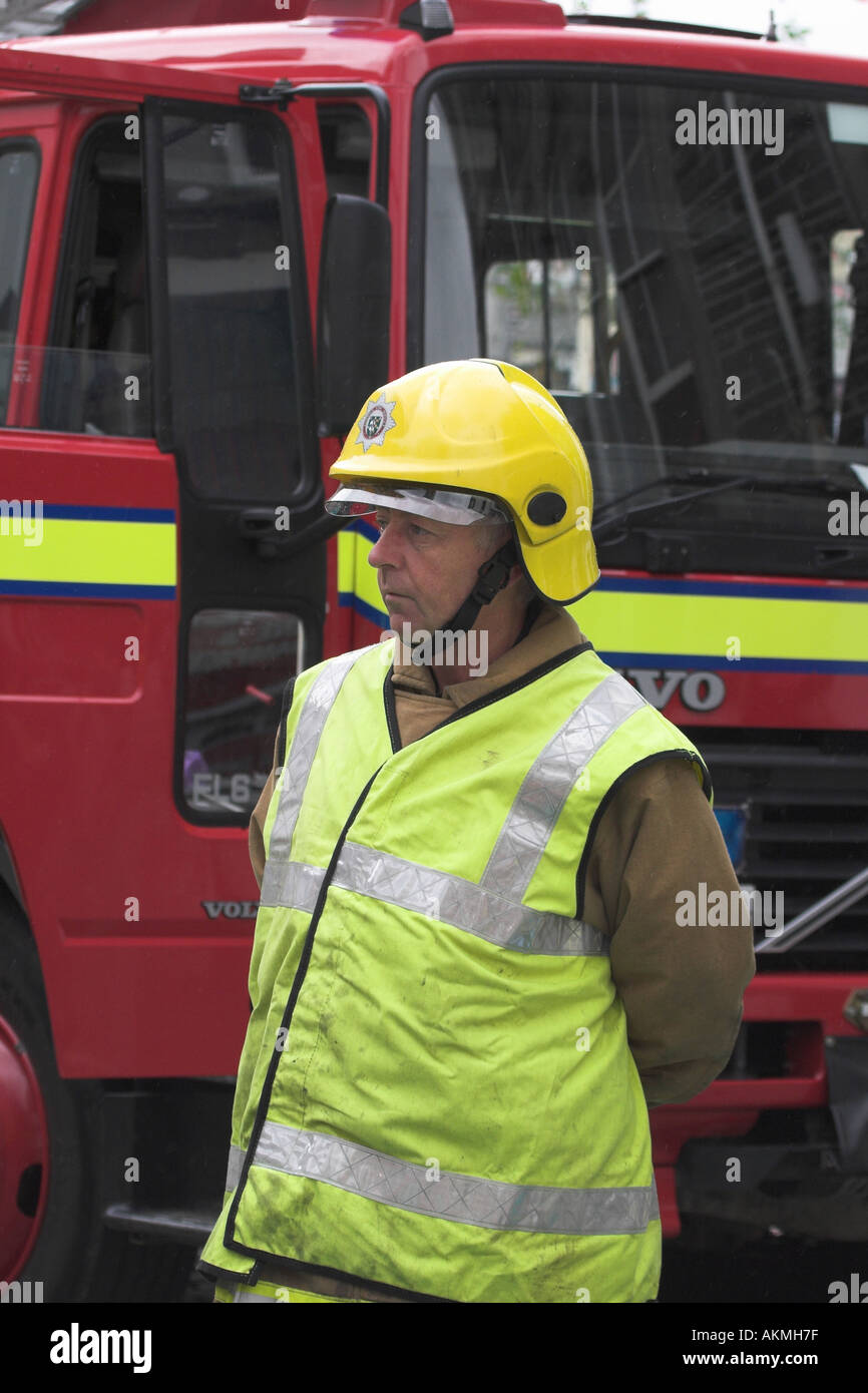 fireman and a firetruck behind him Stock Photo - Alamy