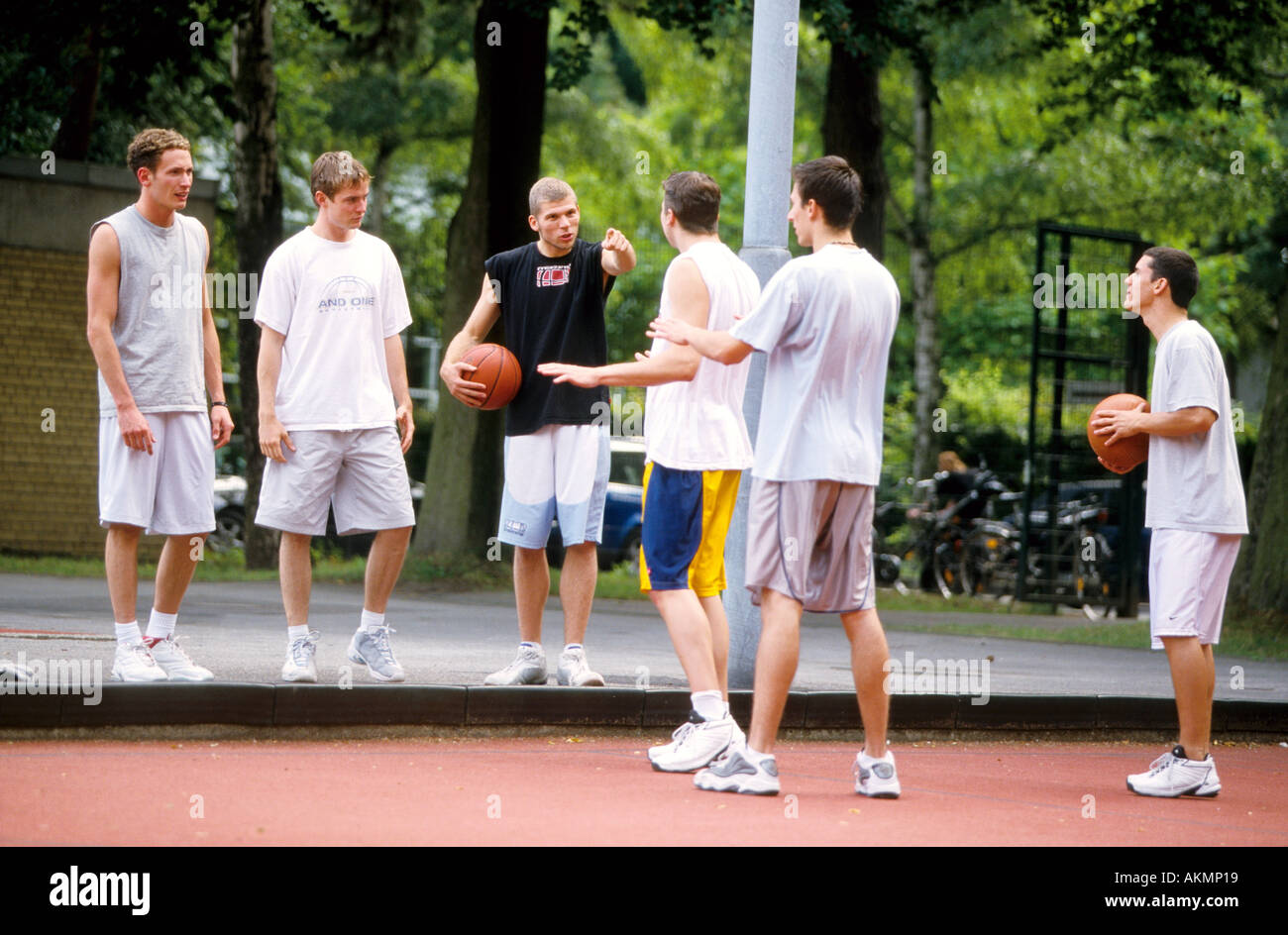 Germany Free time Young men playing basketball Stock Photo - Alamy
