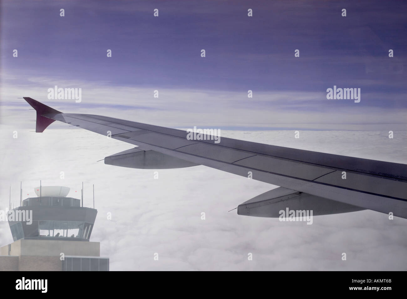 Air traffic control tower and airplane in flight Stock Photo - Alamy