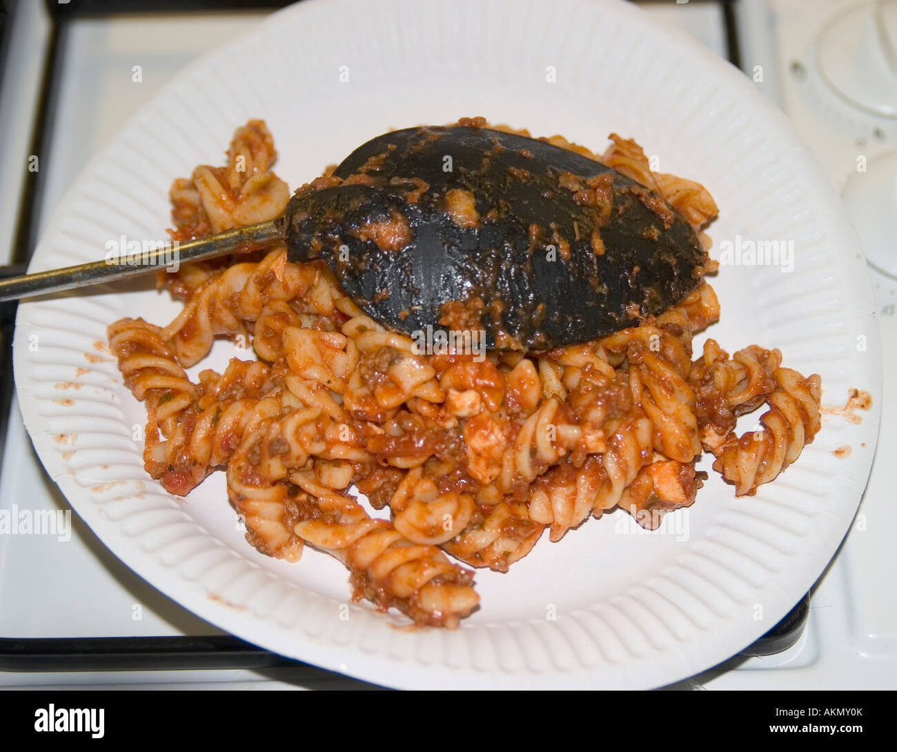 Pasta on paper plate with serving spoon. Indicating bad service Stock ...