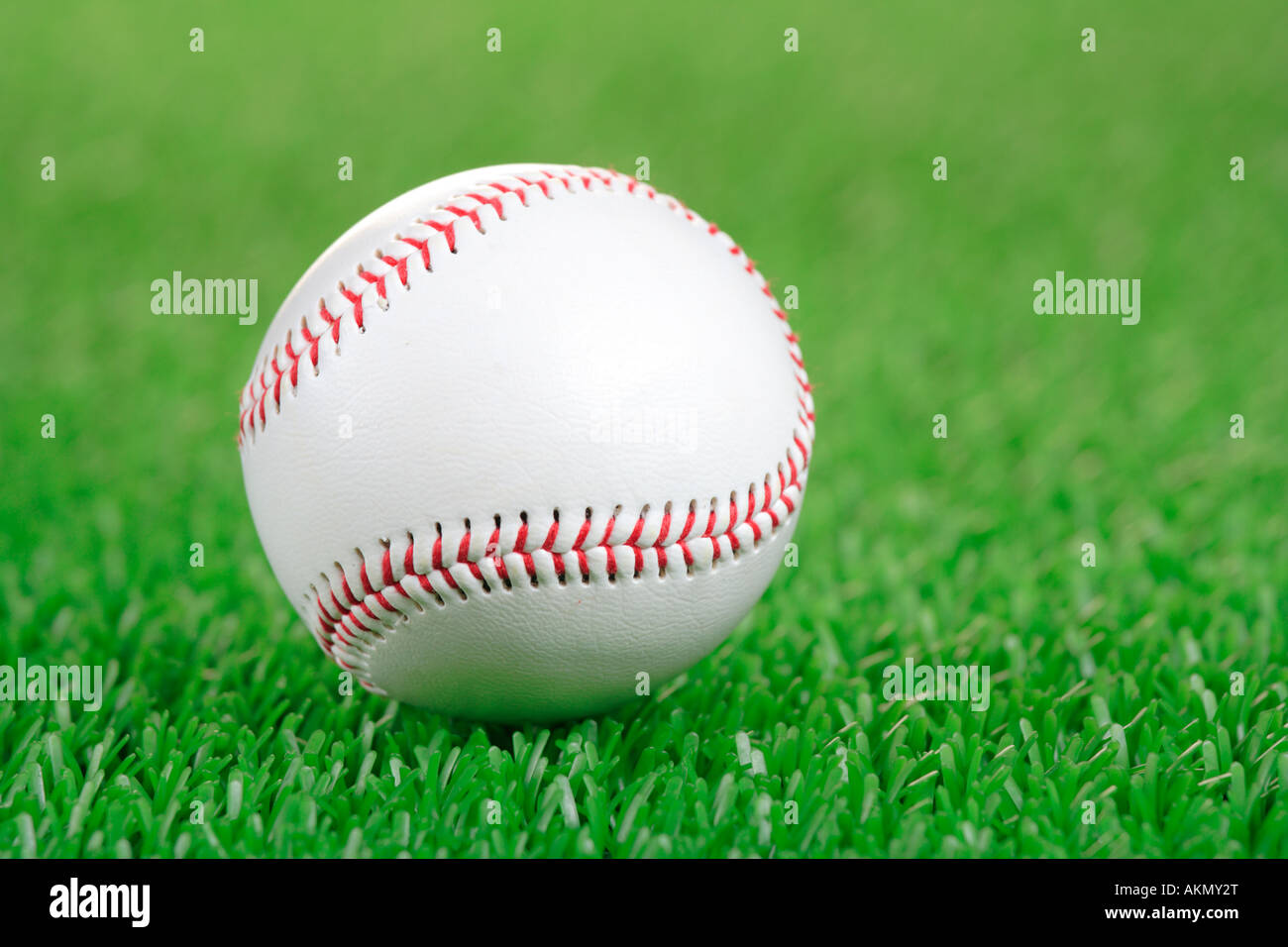 Baseball ball on a grass background Stock Photo - Alamy