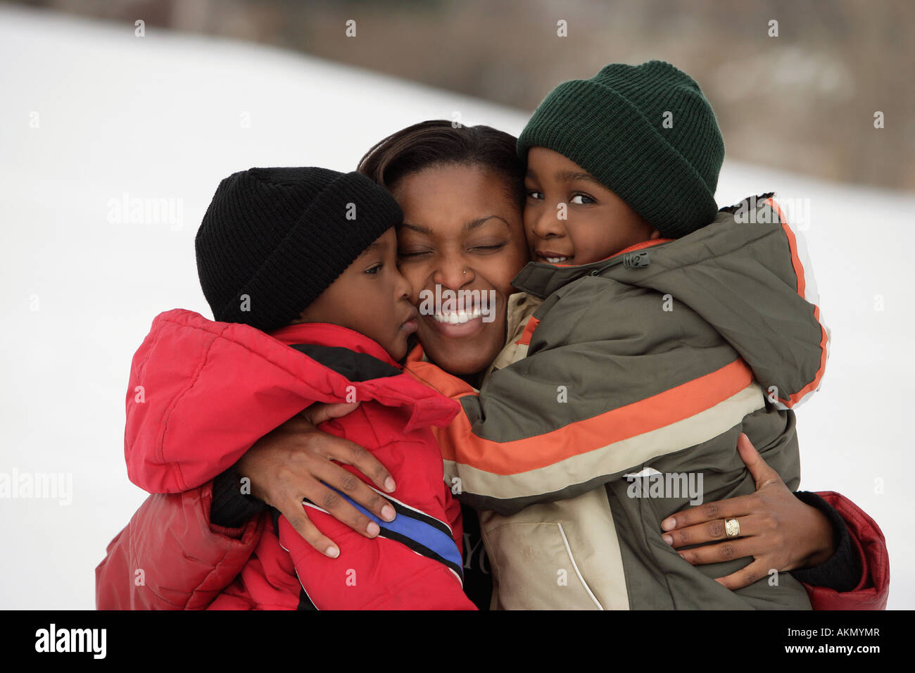 Mother hugging her children Stock Photo - Alamy