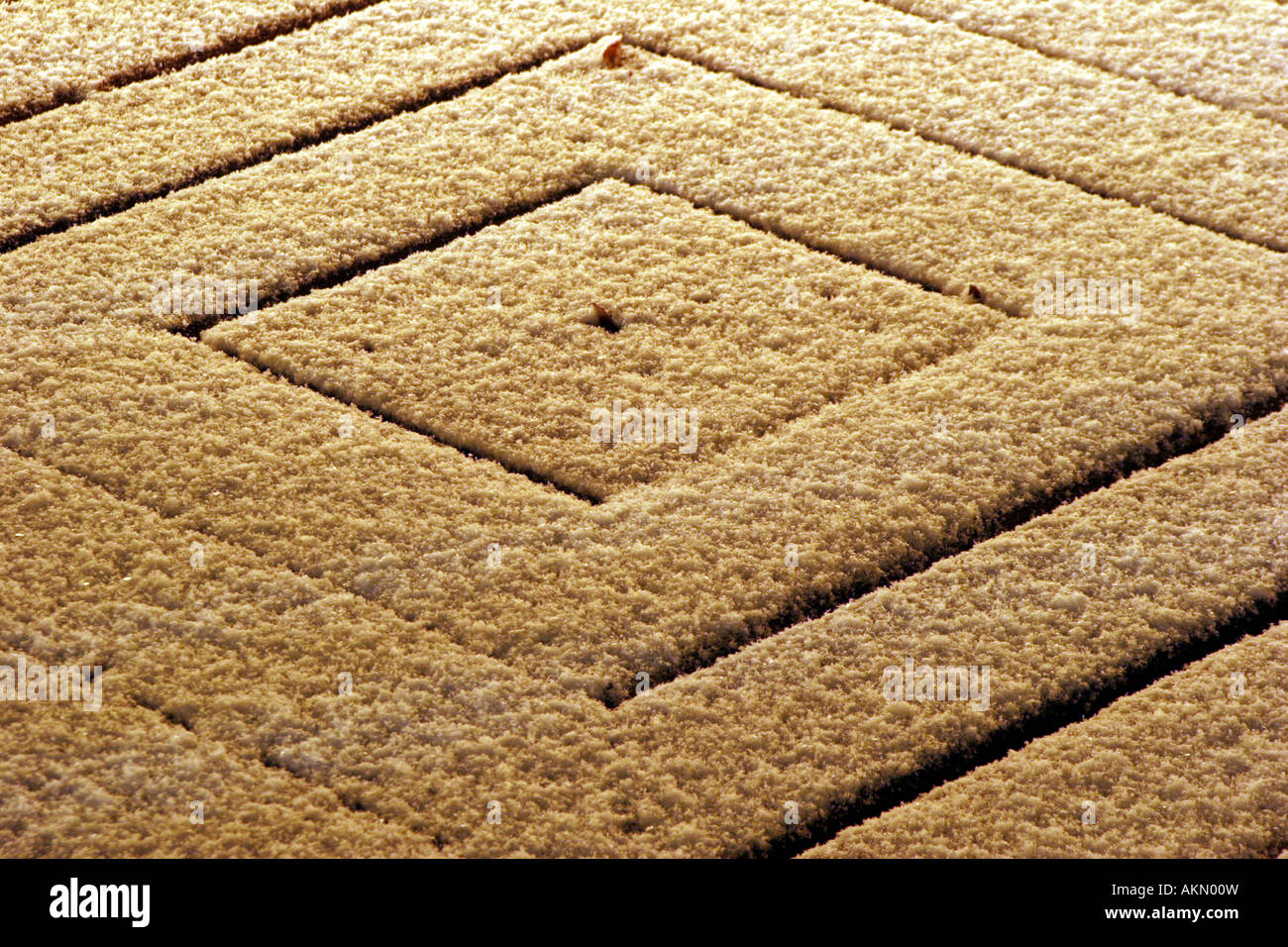 Snowflakes on a diamond patterned planked deck outside Stock Photo - Alamy