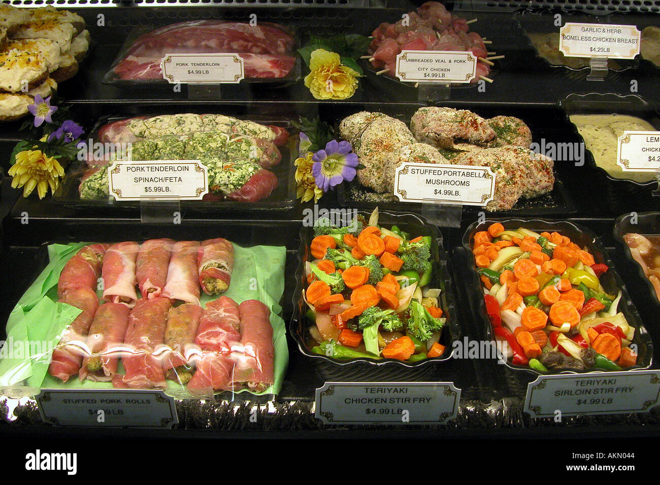 Prepared meats and vegetables on display at a Farmer s Market store ...
