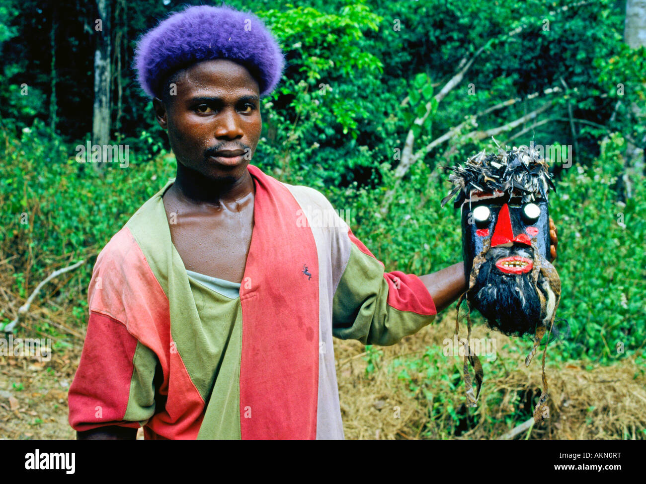A man holds a traditional animist tribal mask Stock Photo - Alamy