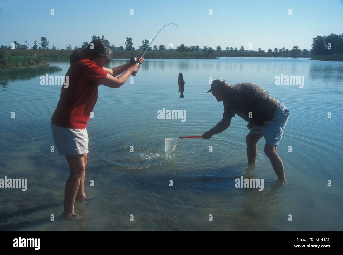 Couple Catching Fish Stock Photo - Alamy