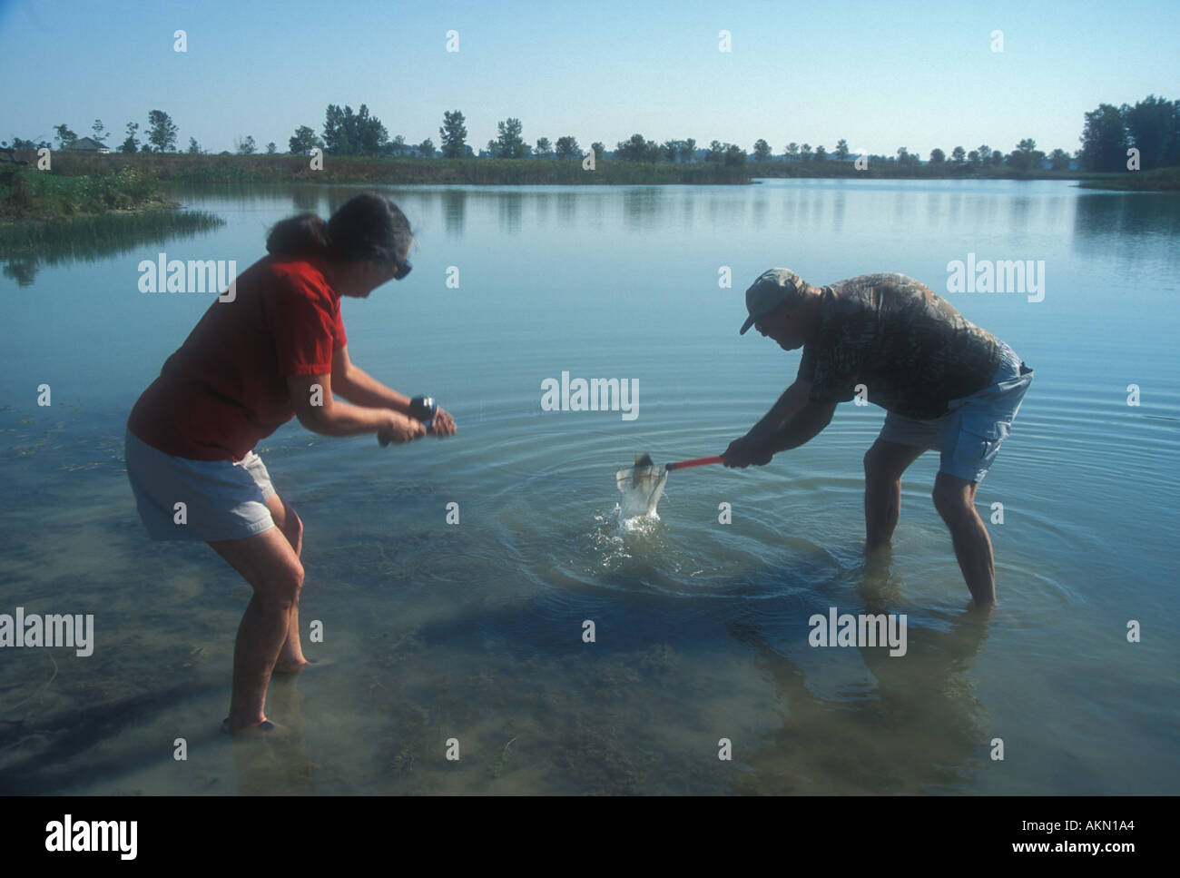 Couple Catching Fish Stock Photo - Alamy