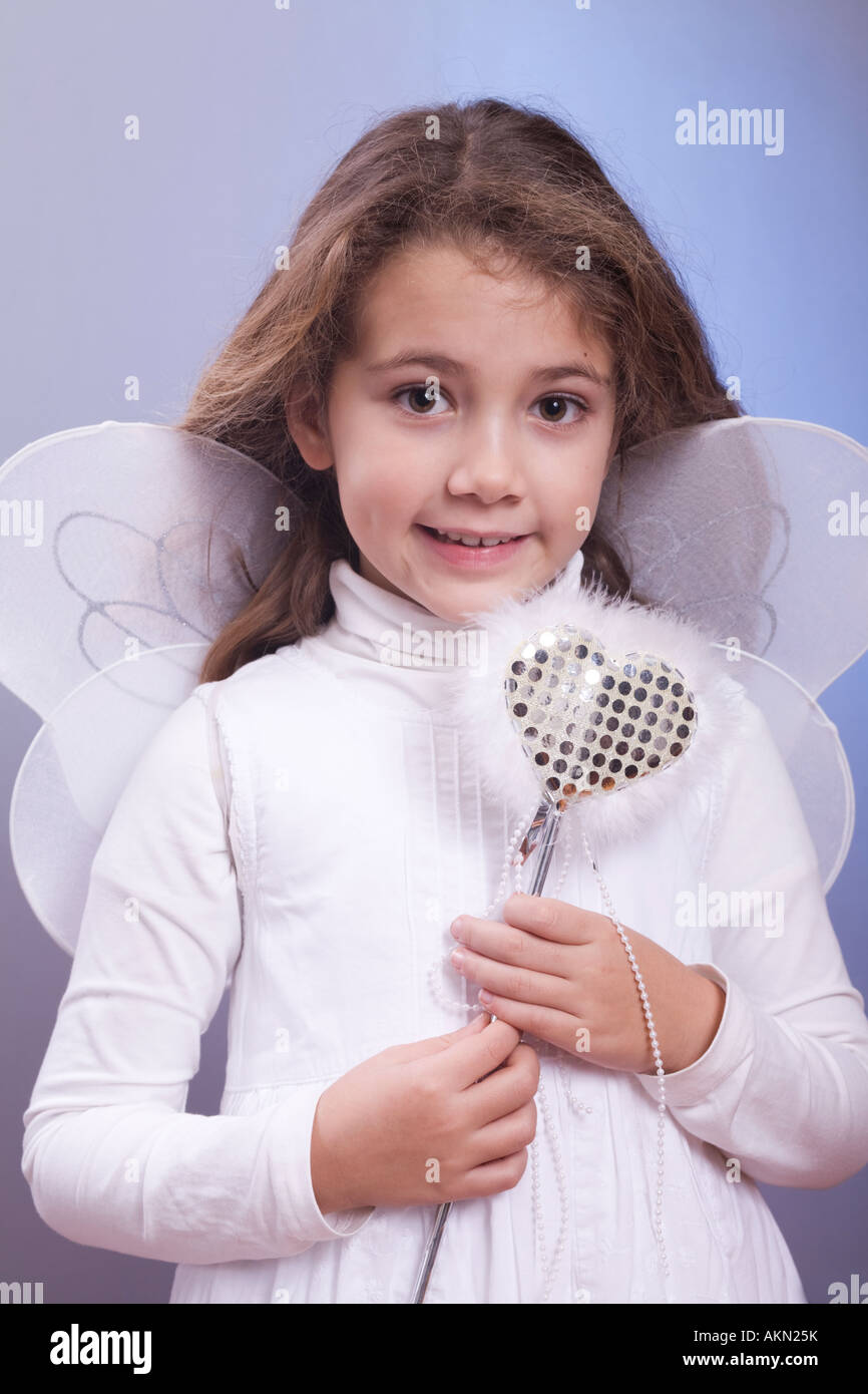 Little angel in white holding fairy stick Stock Photo - Alamy