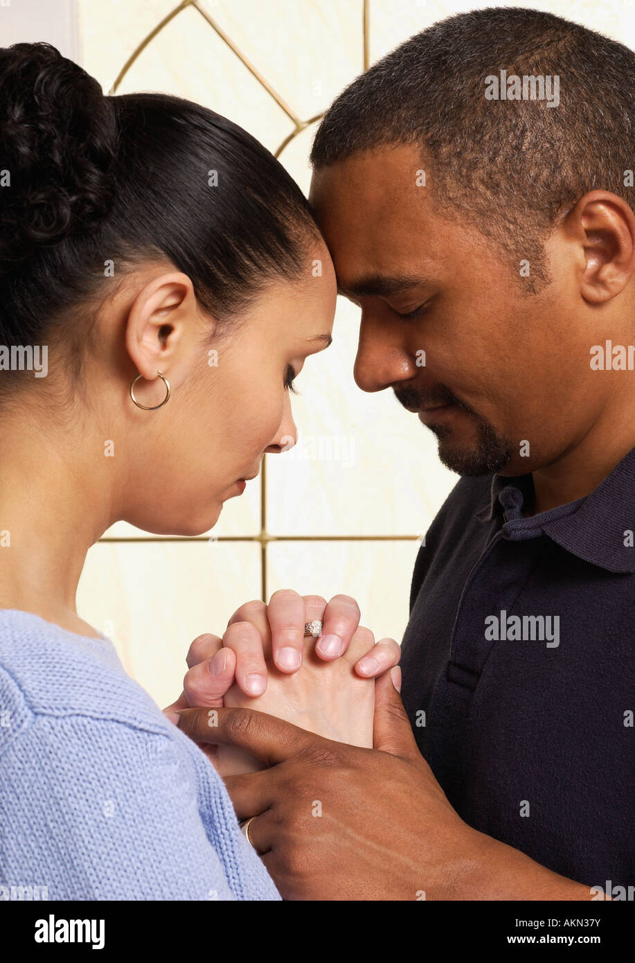 Couple praying together Stock Photo - Alamy