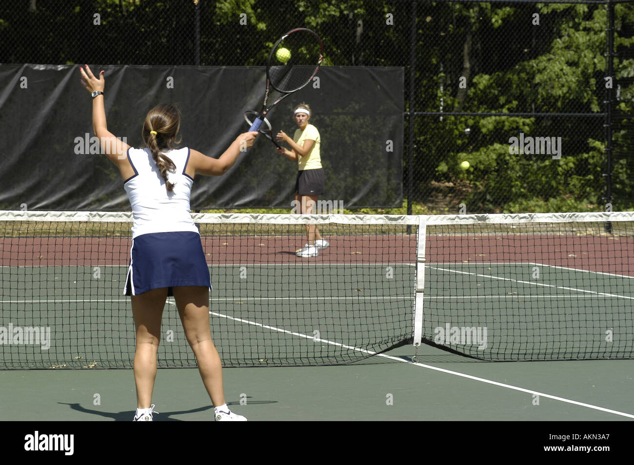 Female doubles match at a high school tennis meet Stock Photo - Alamy