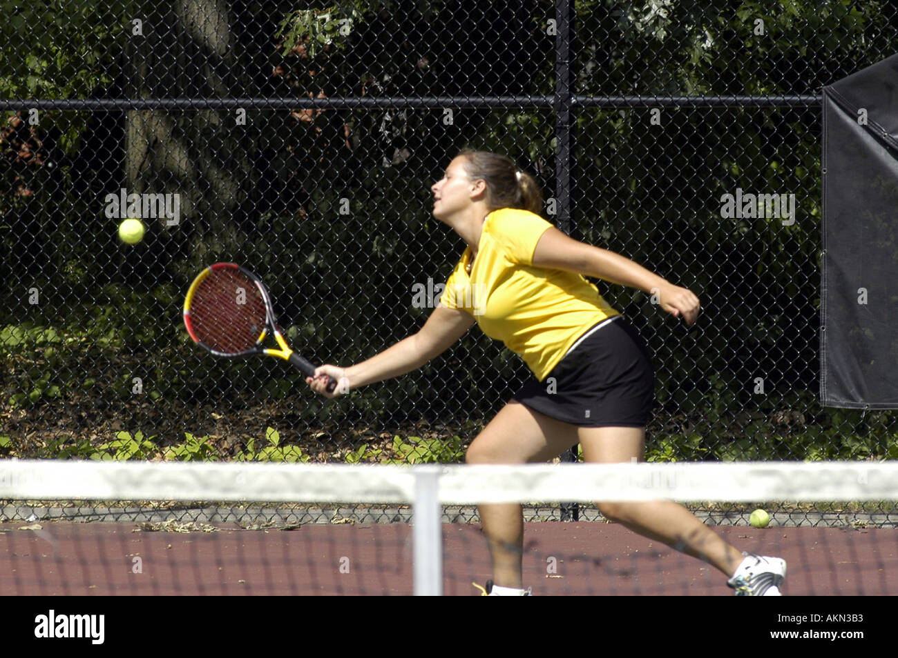 Female doubles match at a high school tennis meet Stock Photo - Alamy
